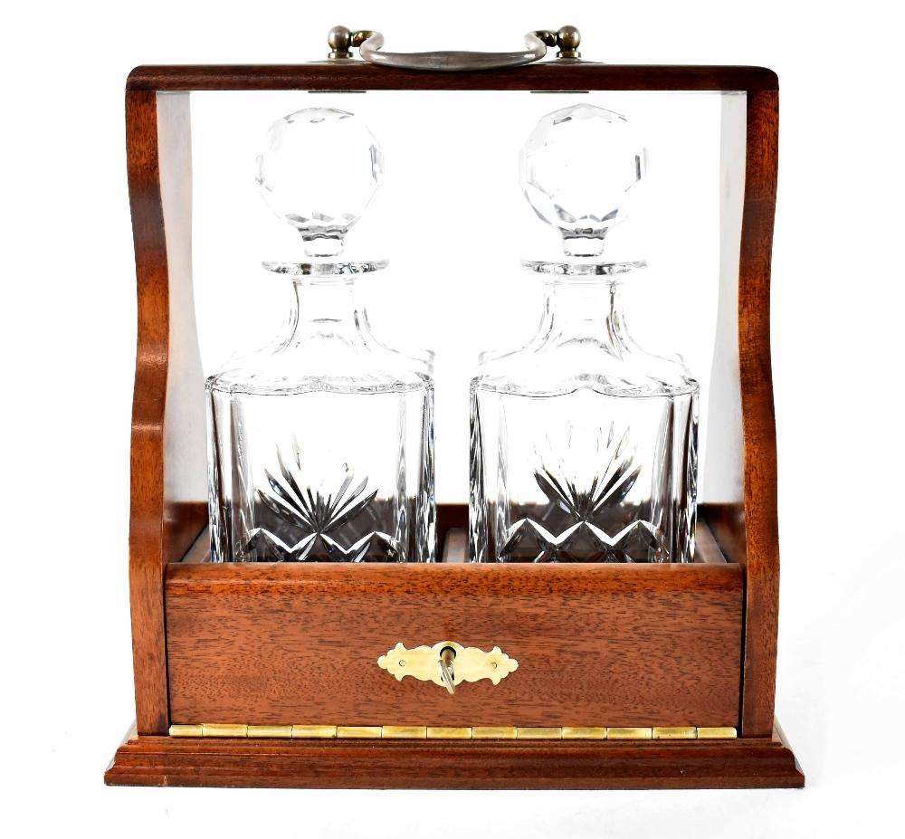 A modern oak twin-bottle tantalus. | Adam Partridge