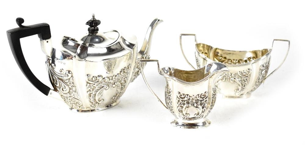 A Victorian hallmarked silver three-piece tea service with scroll ...