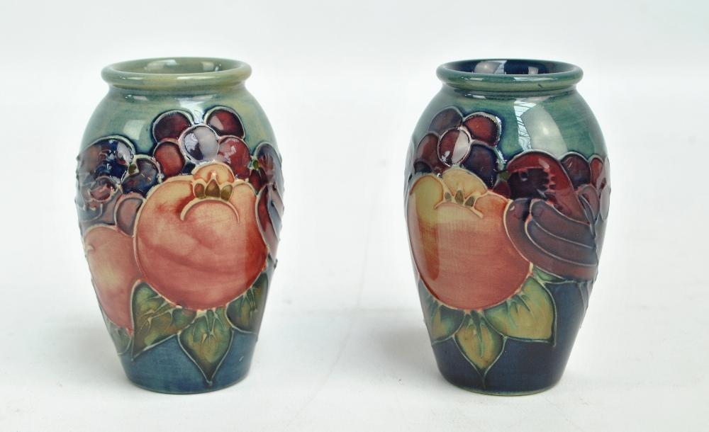 MOORCROFT; a pair of tubeline decorated 'Finches' pattern inverted ...