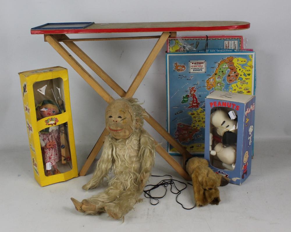 A mixed group of toys including Merrythought monkey, bear hand puppet ...