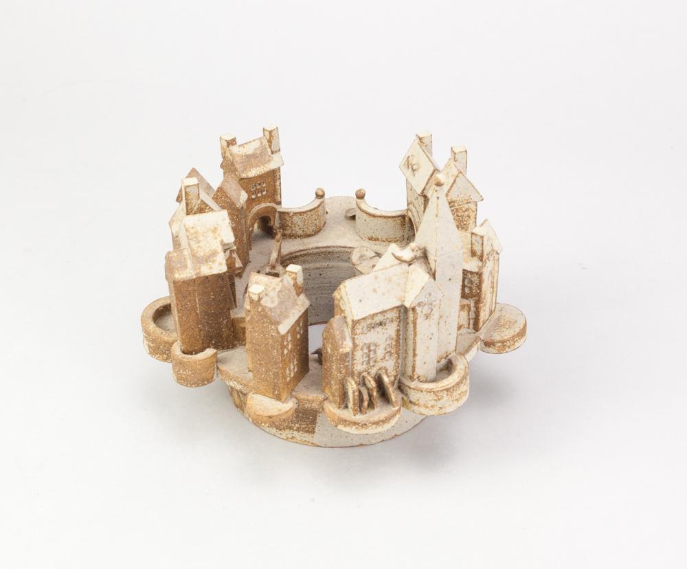 PAUL GANDY (born 1930); a stoneware sculpture a church, houses and ...