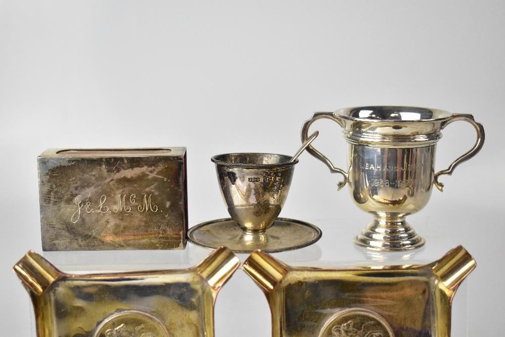 A small collection of silverware comprising a small silver twin-handled ...