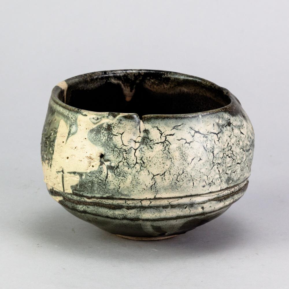 CLAUDE CHAMPY (born 1944); a stoneware chawan covered in black, grey ...
