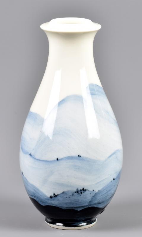 RICHARD HEELEY; a porcelain bottle with cobalt landscape decoration ...